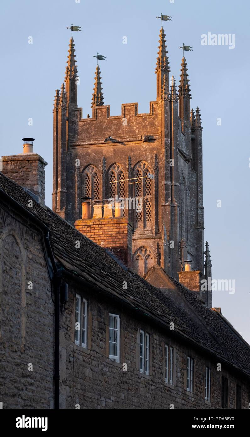 The tower of St Andrew's Church rises above local houses in the ...