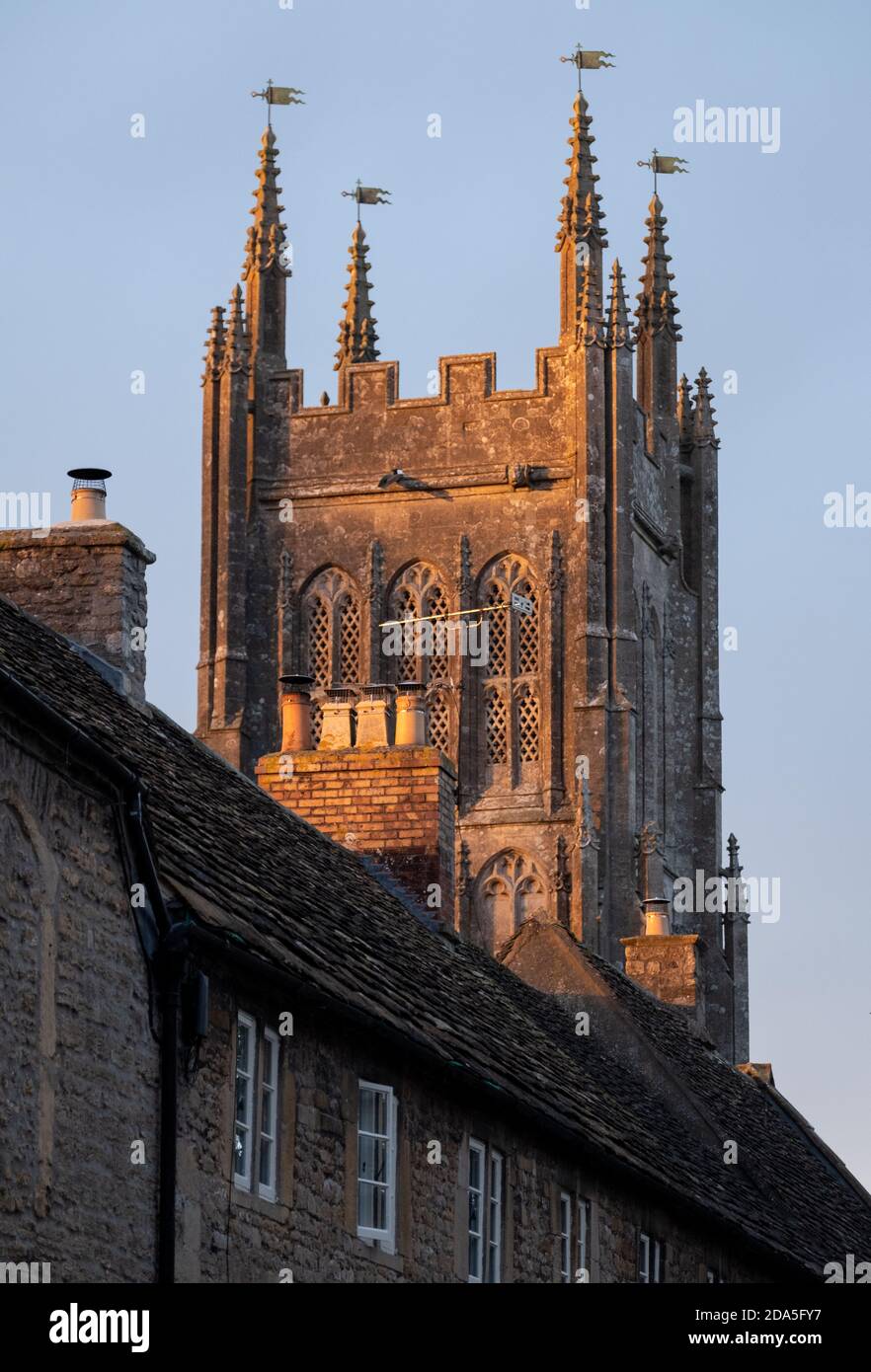 The tower of St Andrew's Church rises above local houses in the ...
