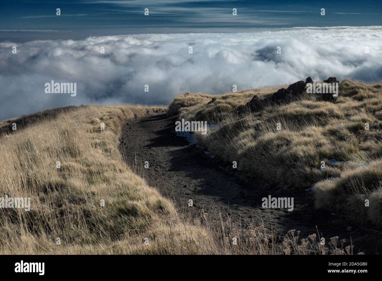 high altitude trail above the low clouds in Etna Park, Sicily Stock ...