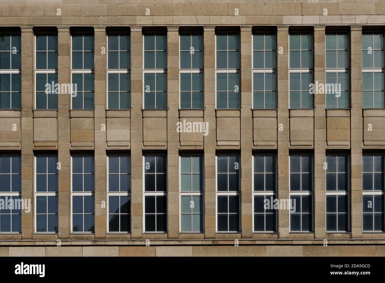 Front exterior view of modern facade with cream brown rough granite ...