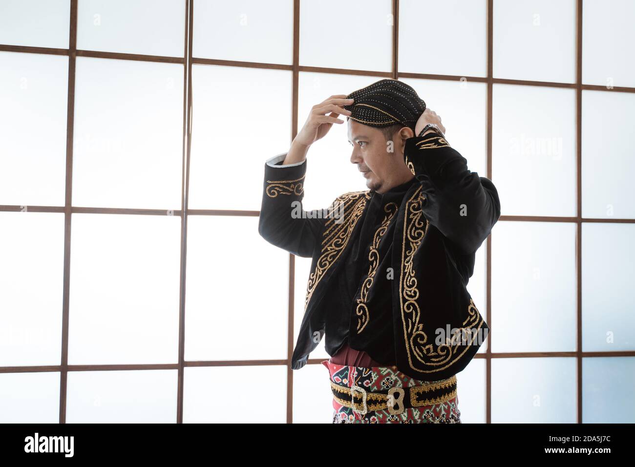 A portrait of a costume traditional Javanese man. standing by the ...