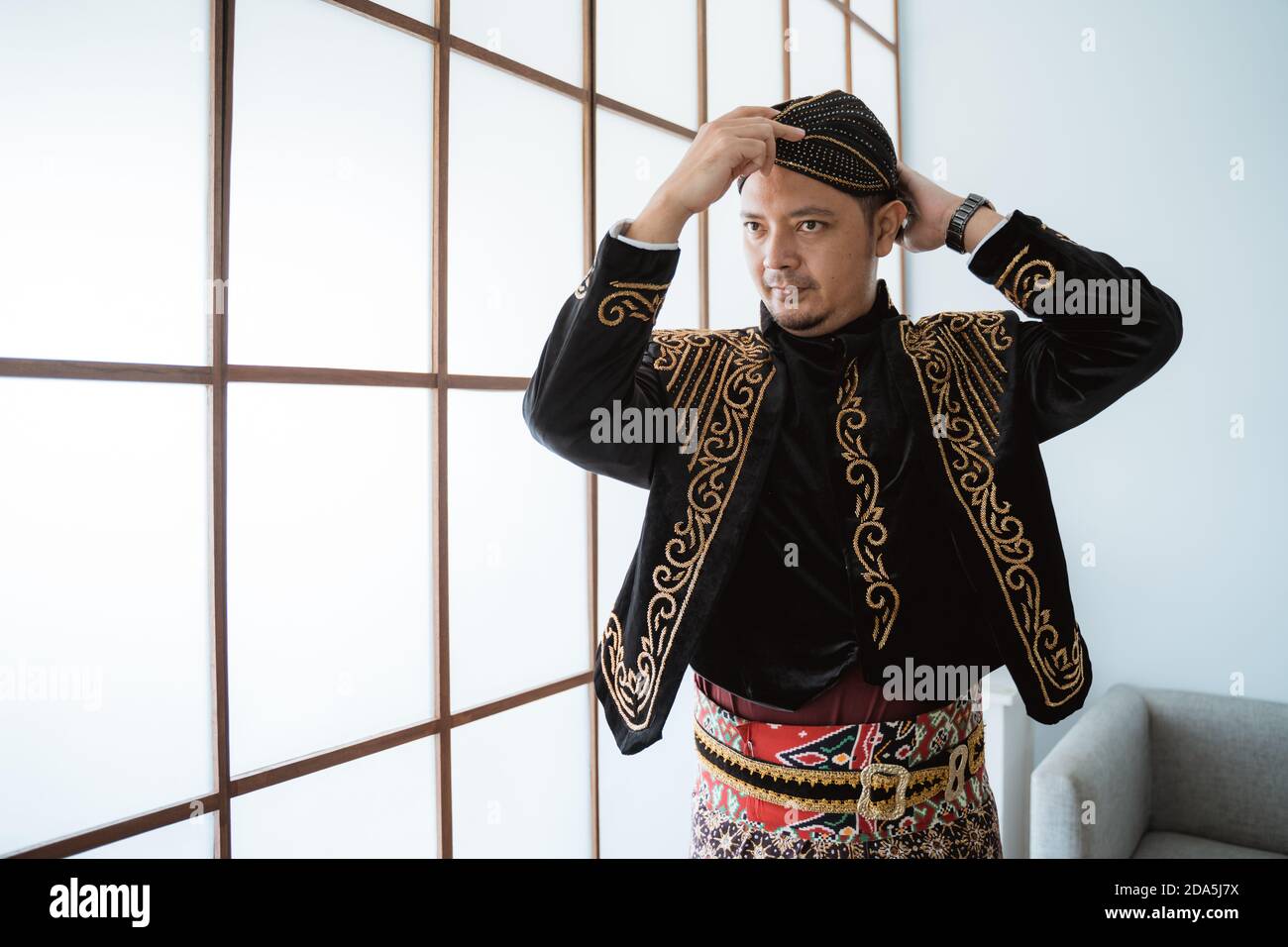 A portrait of a costume traditional Javanese man. standing by the ...