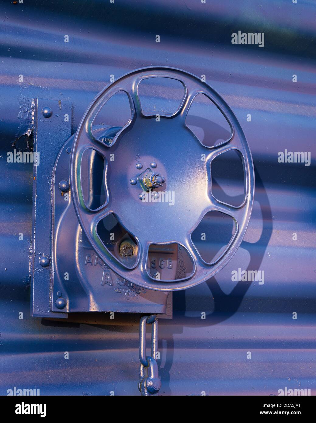 Blue and purple metal spinning wheel on back of vintage caboose ...