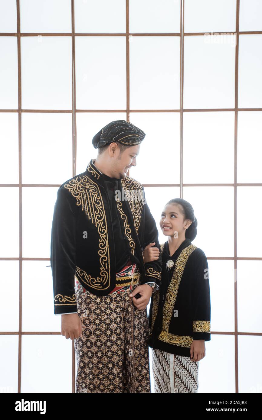 A portrait of father and daughter Javanese traditional clothes ...