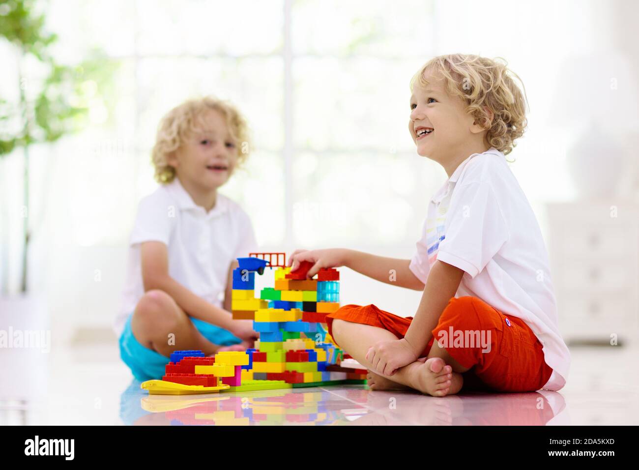 Child playing with colorful toy blocks. Kids play with plastic bricks ...