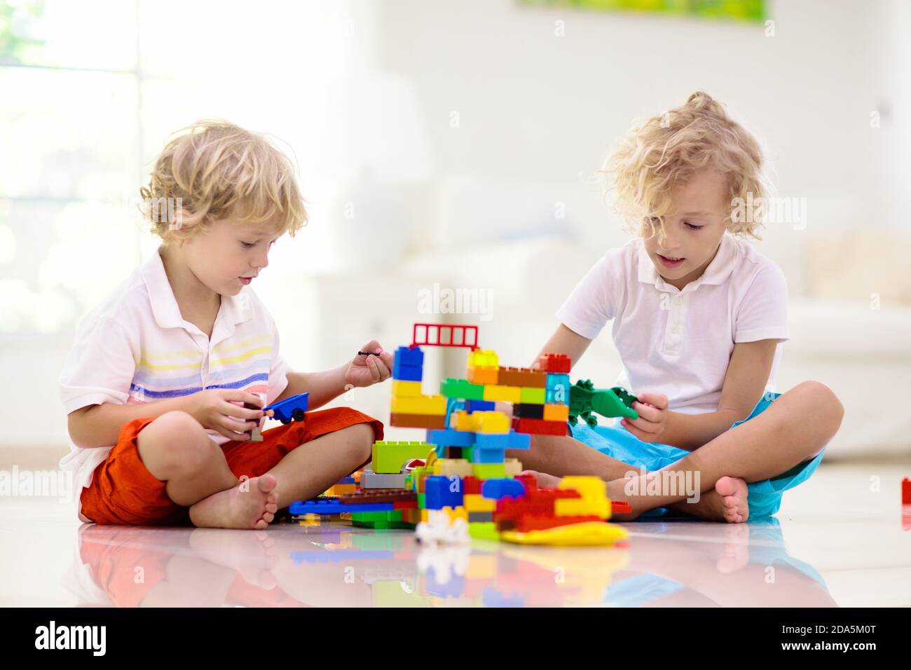 Child playing with colorful toy blocks. Kids play with plastic bricks ...