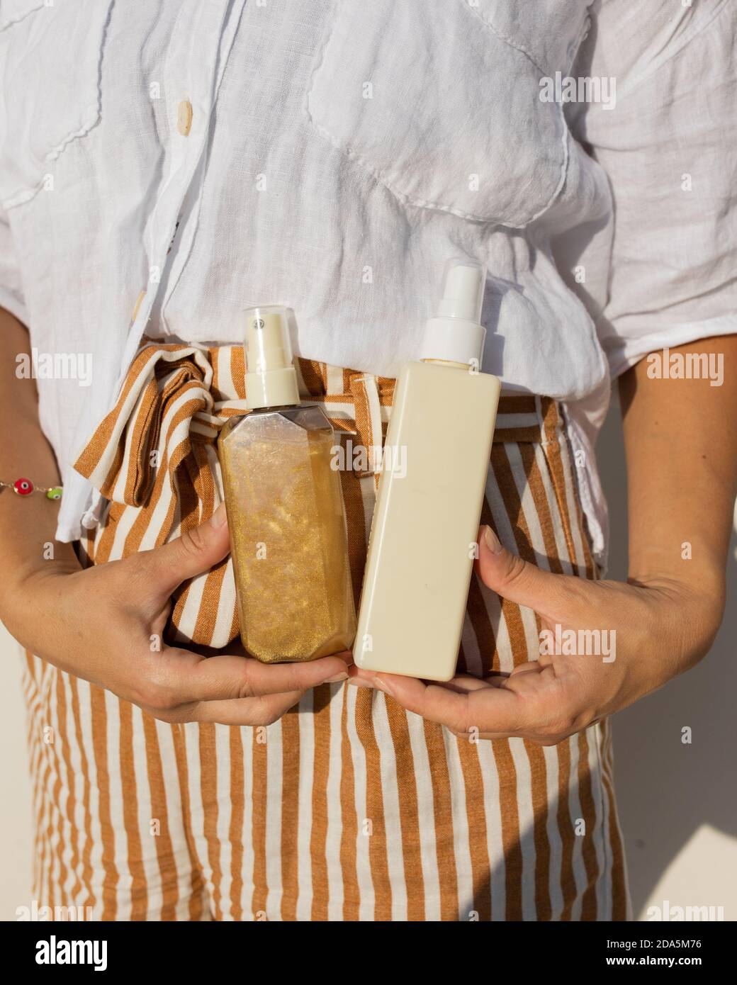 Woman holding skin treatment cosmetics bottles, mock-up Stock Photo - Alamy