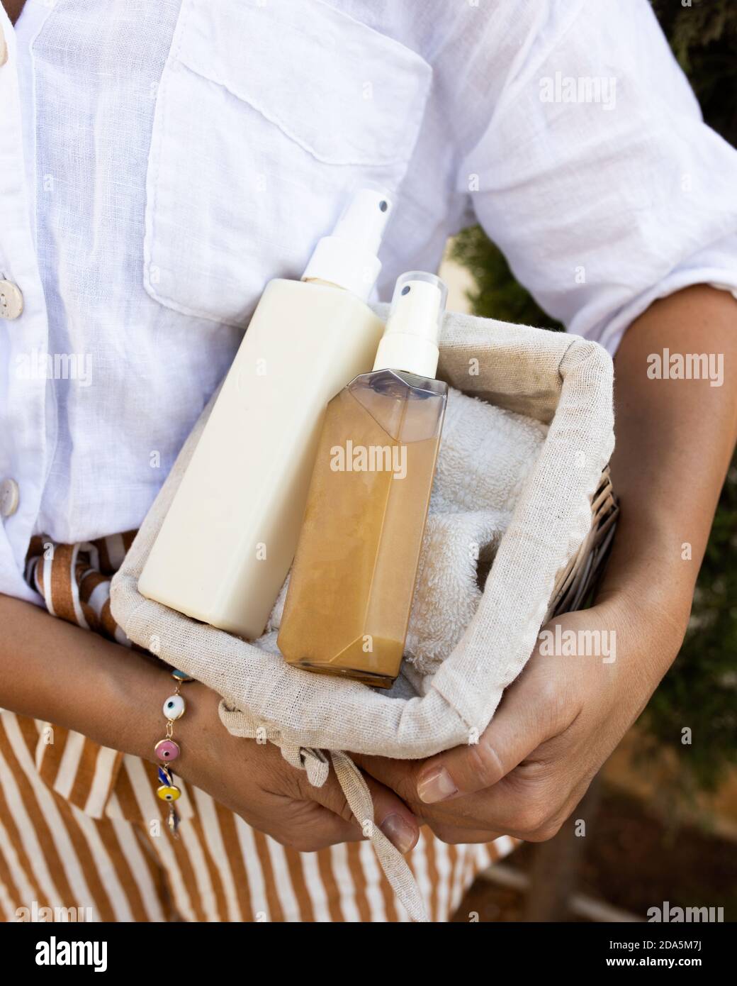 Woman holding skin treatment cosmetics bottles, mock-up Stock Photo - Alamy