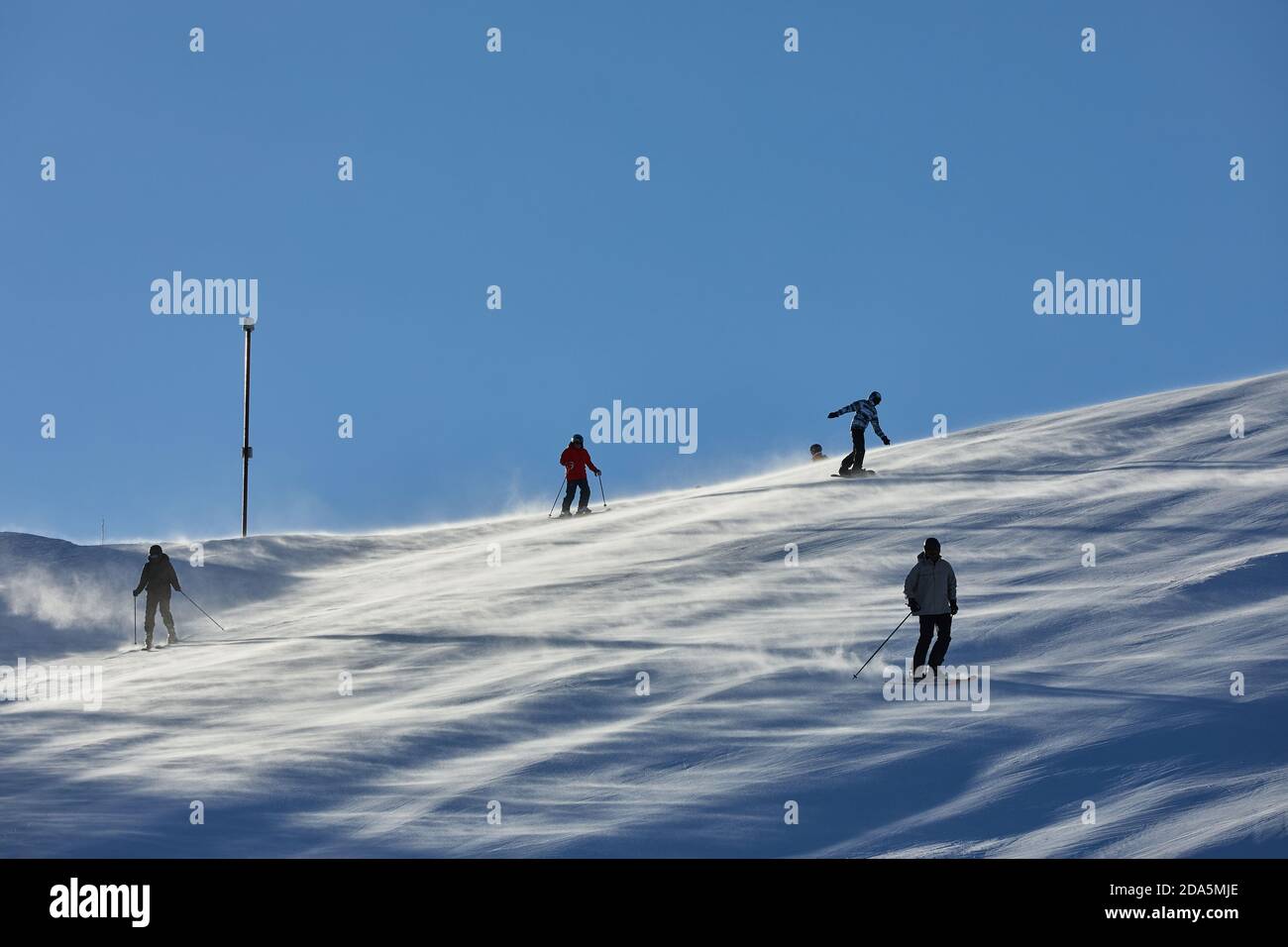 Skiing slopes with skiers Stock Photo - Alamy