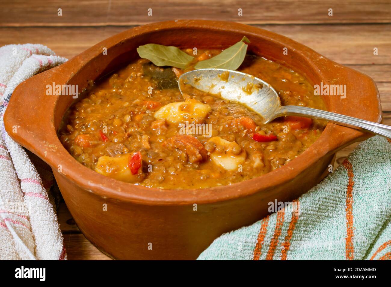 Clay pot with homemade lentil stew, tomato, Spanish chorizo, meat and ...