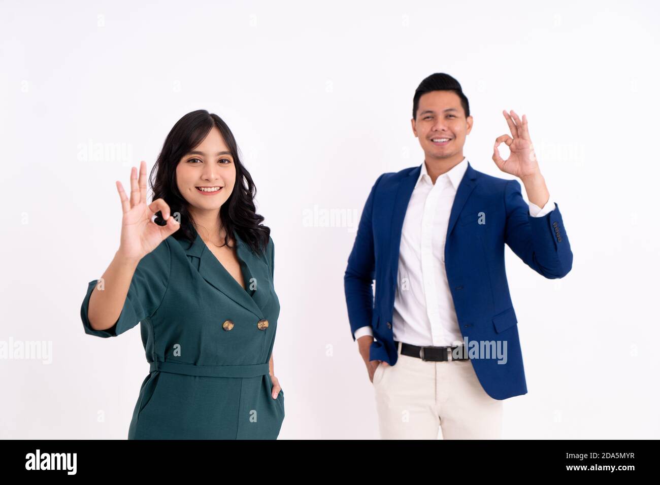 Happy business partner portrait. Showing OK sign Stock Photo - Alamy