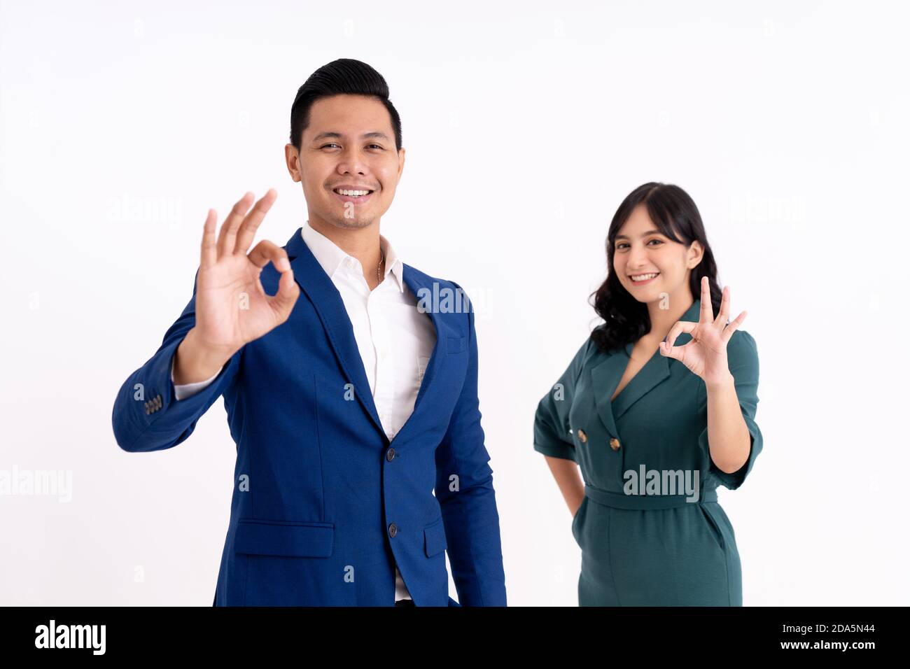 Happy business partner portrait. Showing OK sign Stock Photo - Alamy