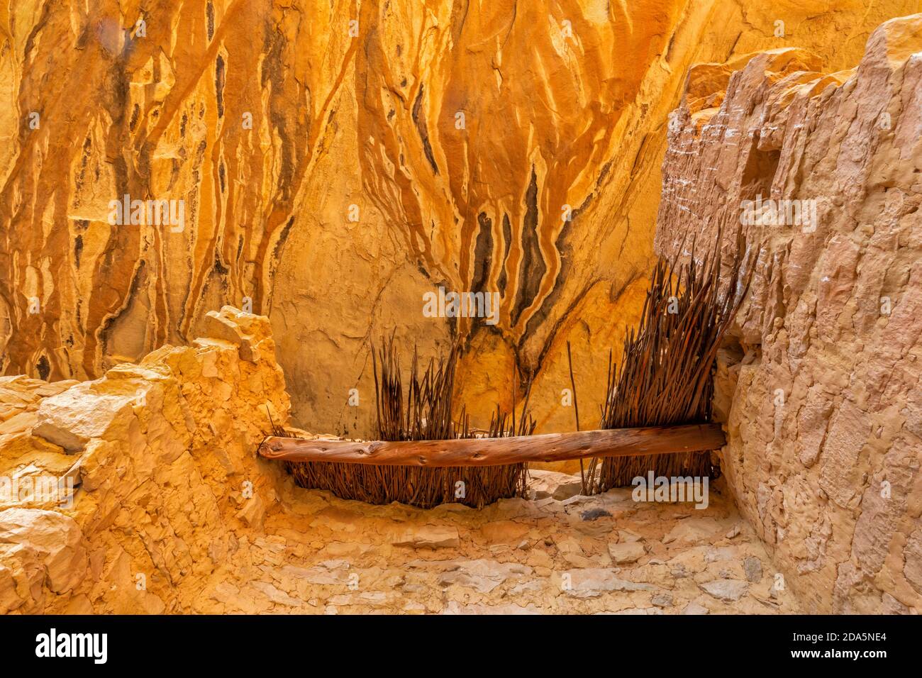 Looking up at a partial roof and water stained ceiling of the well ...