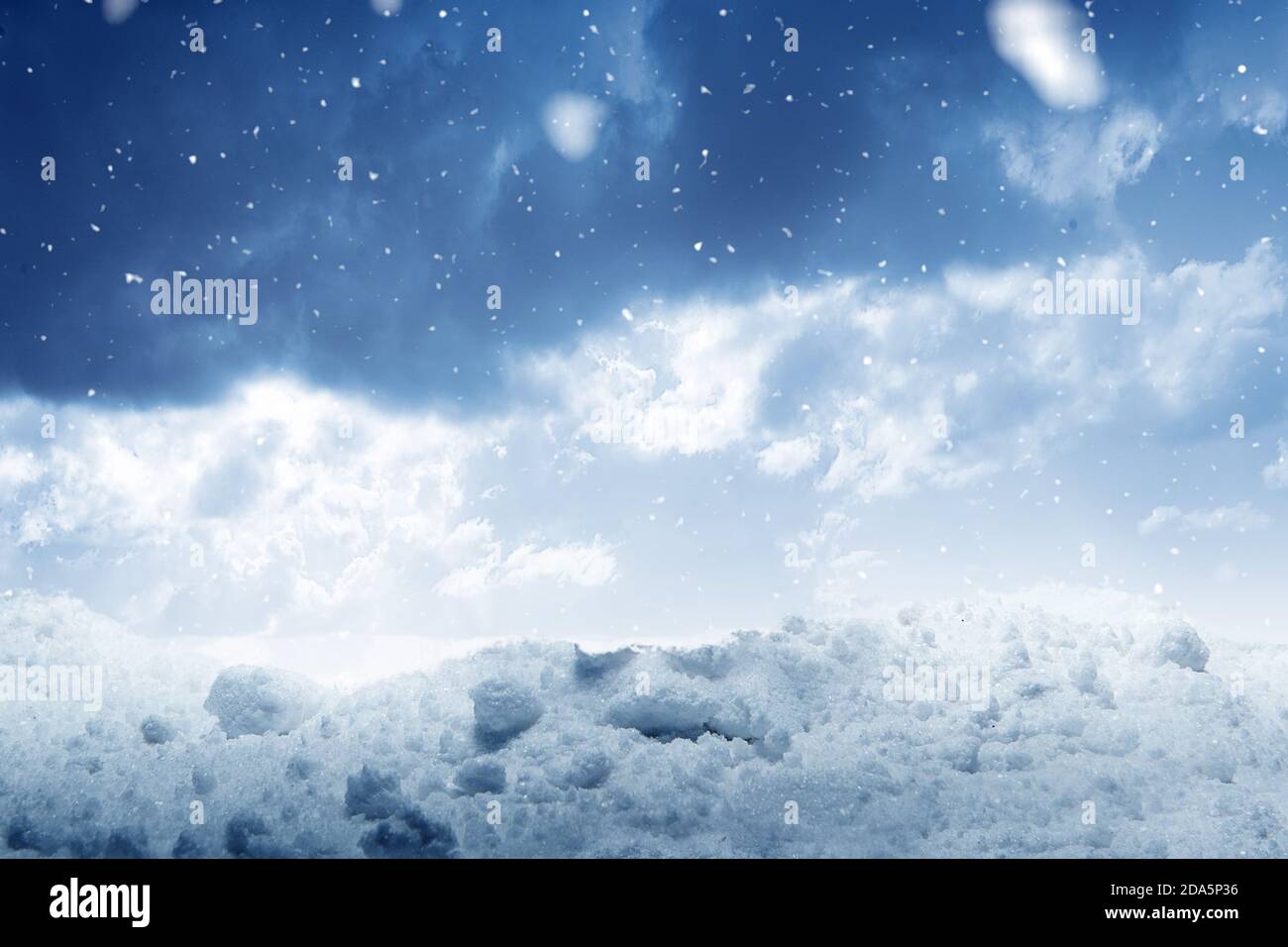 Snowfall in winter with a blue sky background Stock Photo - Alamy