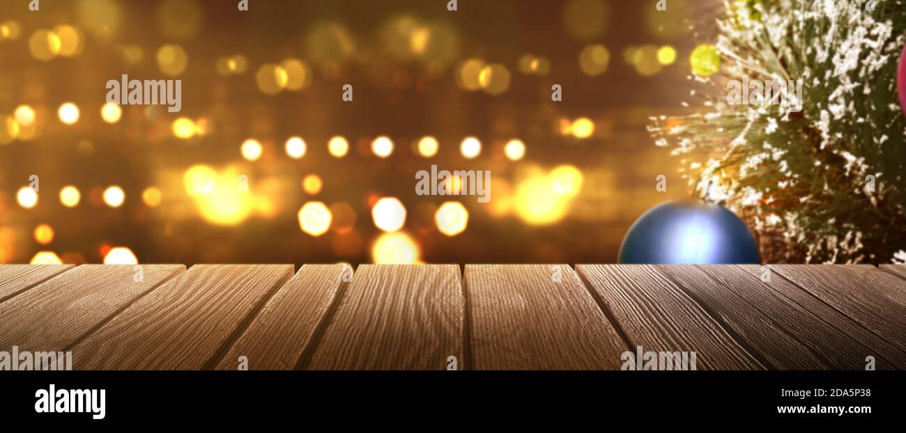 Wooden table with Christmas tree and blurred light background Stock ...