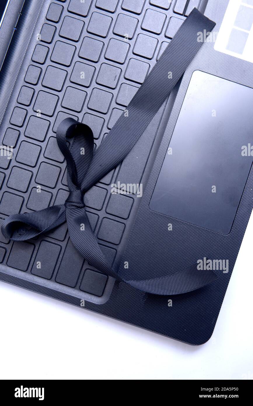 Black ribbon on the laptop isolated over white background Stock Photo ...
