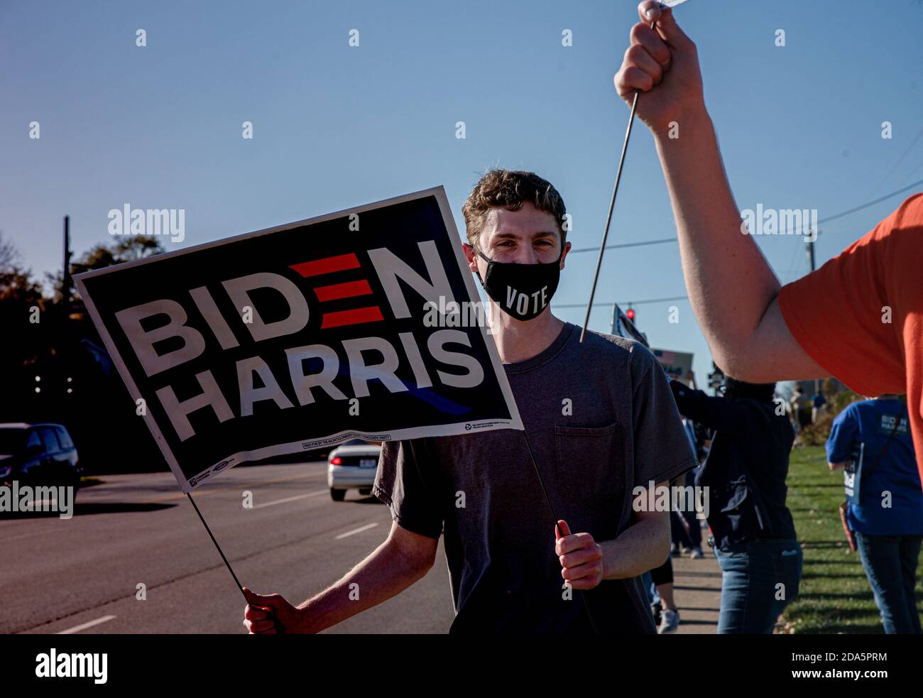 A man holds a placard celebrating Joe Biden's victory. Biden supporters ...