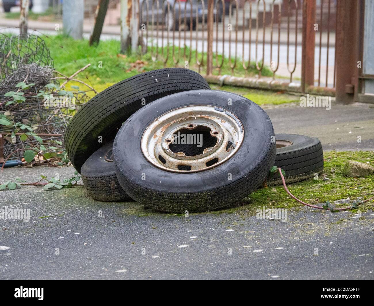 on the floor are some old car wheels with rusty rims Stock Photo - Alamy