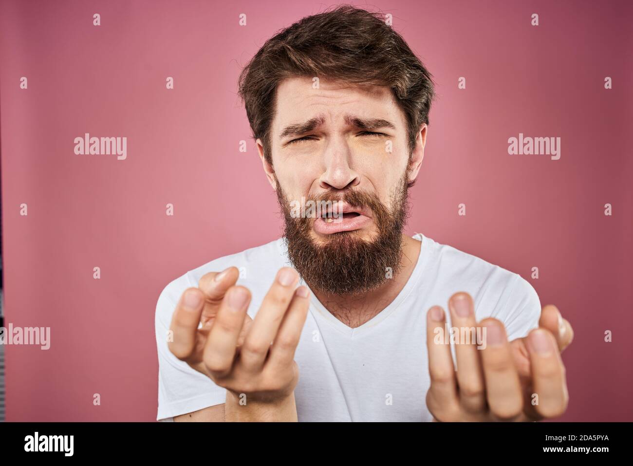 bearded man in white t-shirt emotions displeased facial expression ...