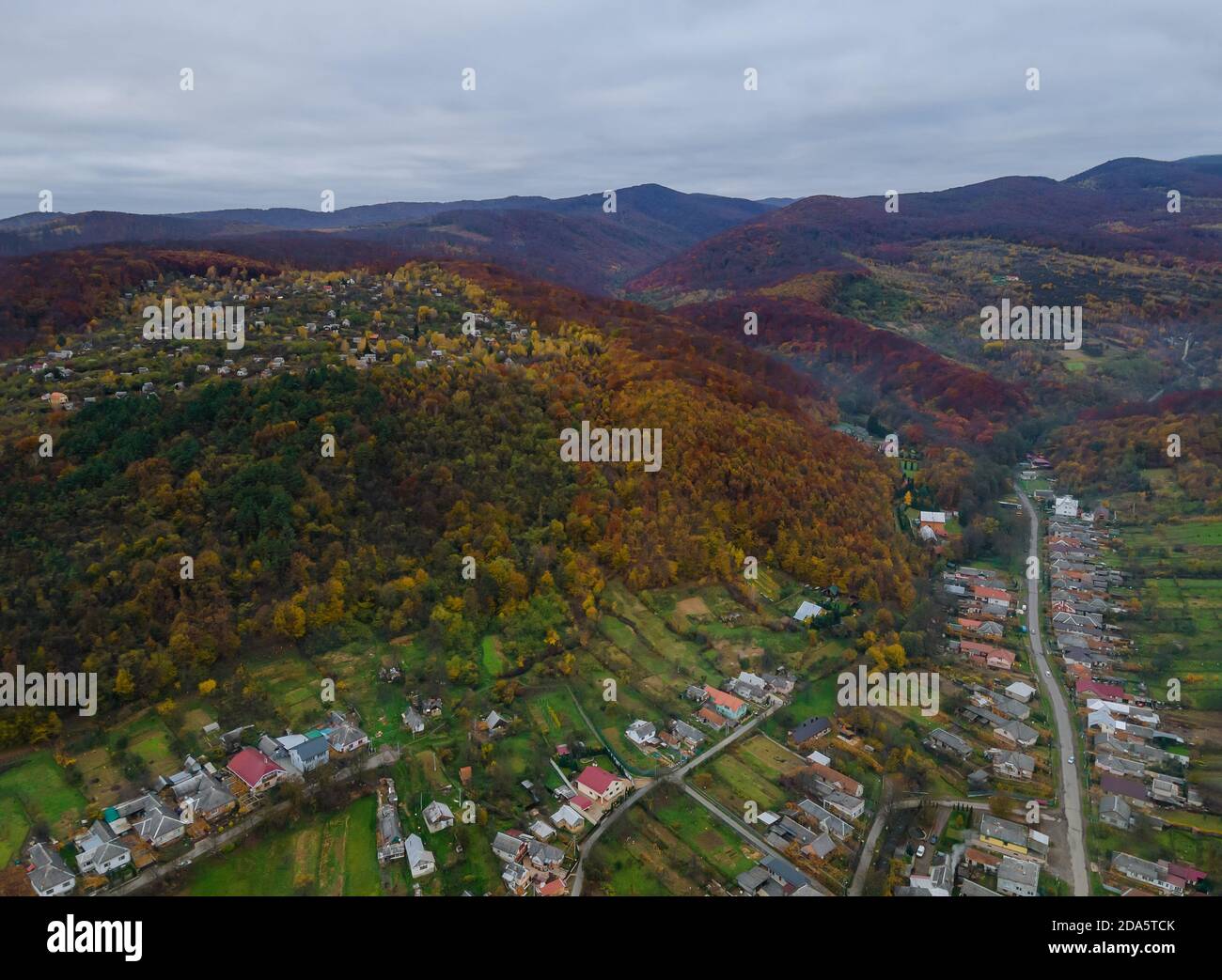 Aerial top dow view over suburb area village near mountain high ...