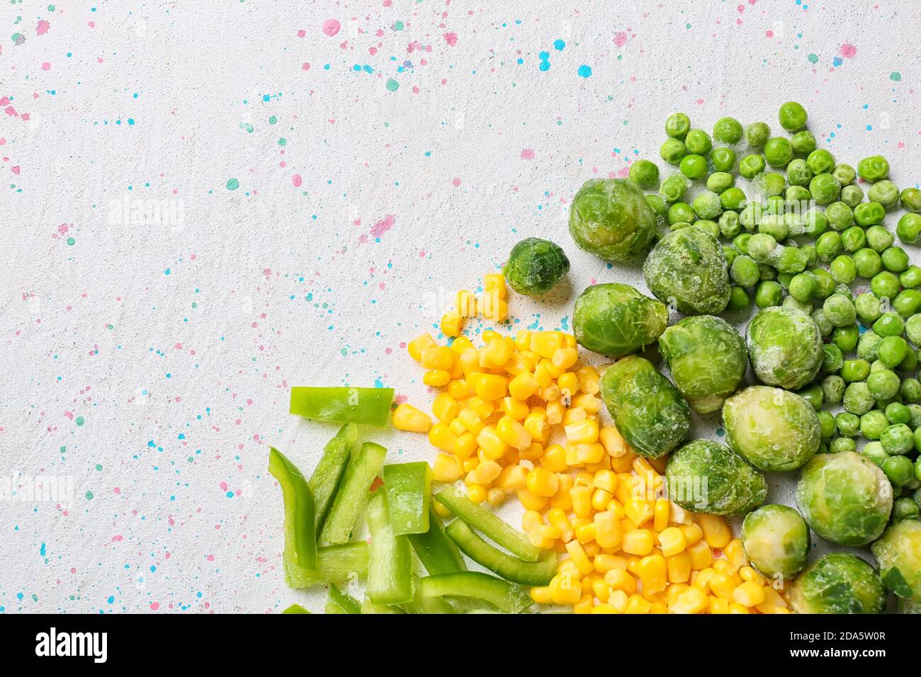 Different frozen vegetables on white background Stock Photo - Alamy