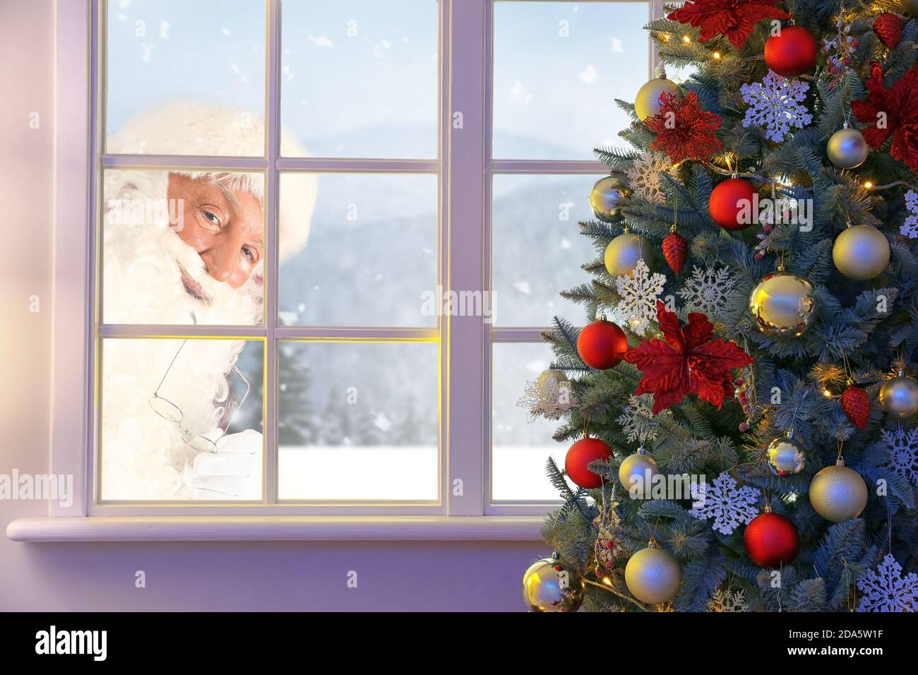Curious Santa Claus looking through the window Stock Photo - Alamy