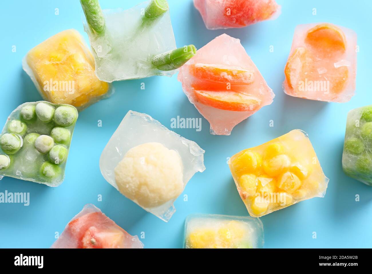 Different frozen vegetables on color background Stock Photo - Alamy