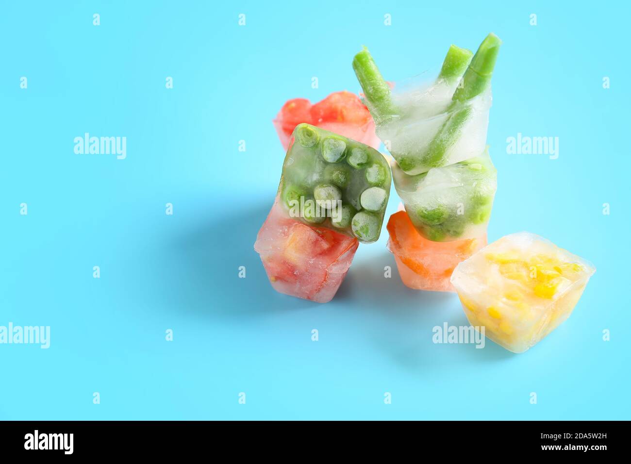 Different frozen vegetables on color background Stock Photo - Alamy