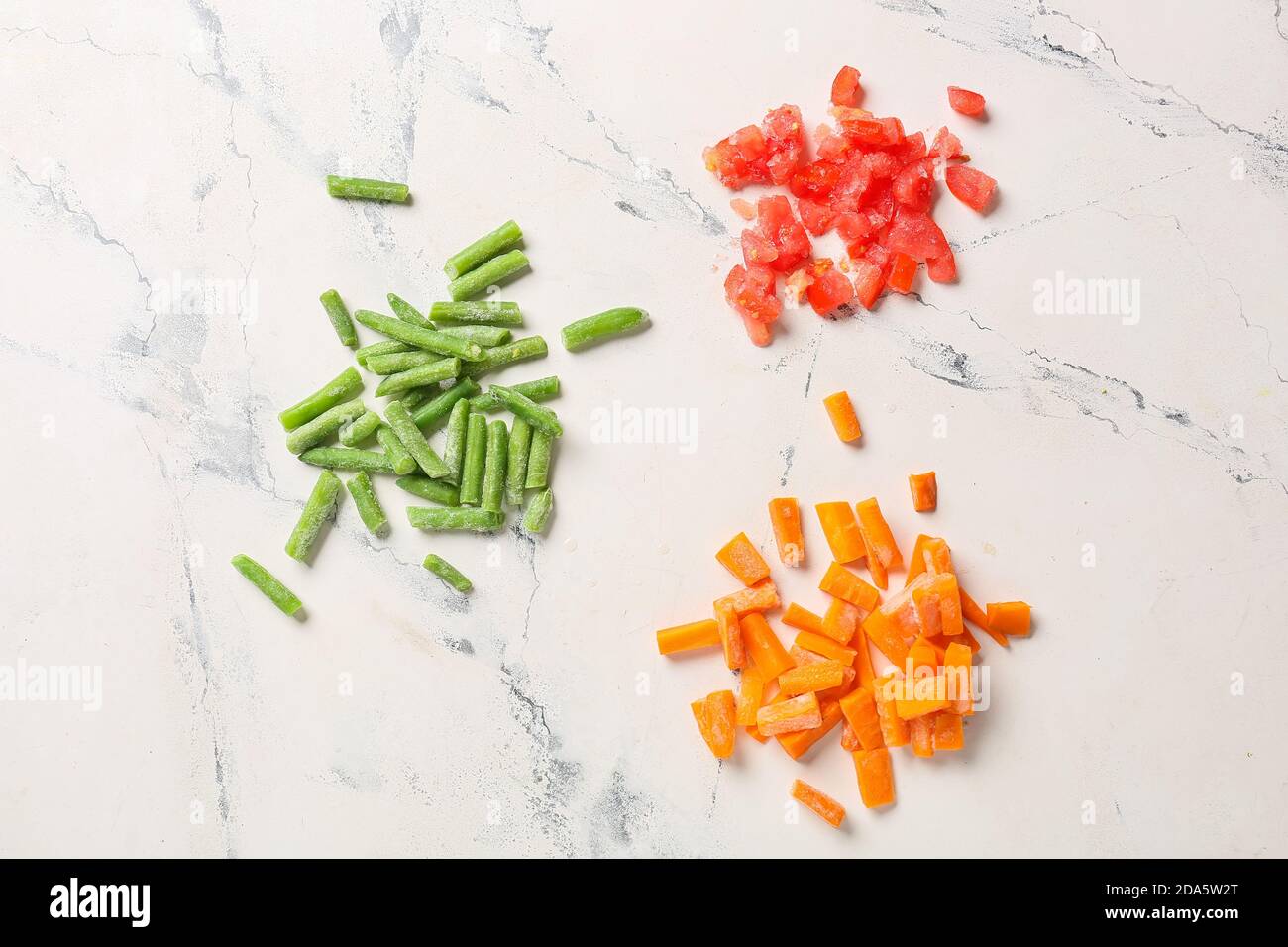 Different frozen vegetables on white background Stock Photo - Alamy