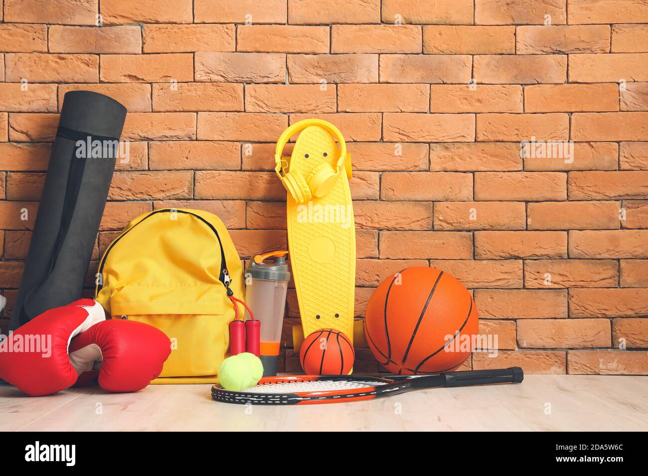 Set of sport equipment on floor near brick wall Stock Photo - Alamy