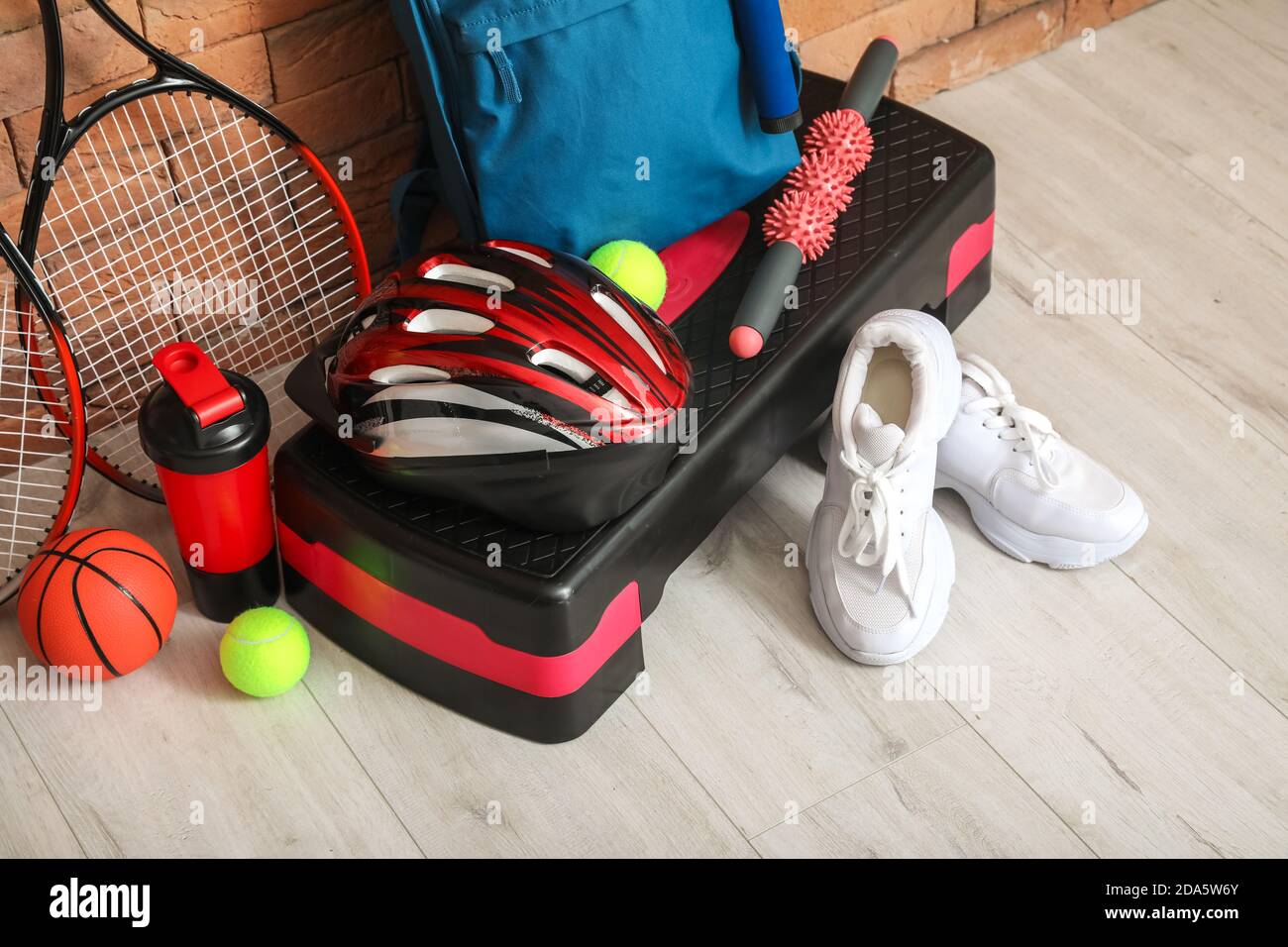 Set of sport equipment on floor near brick wall Stock Photo - Alamy