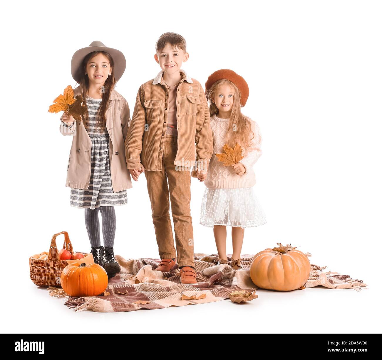 Cute little children in autumn clothes and with pumpkins on white ...