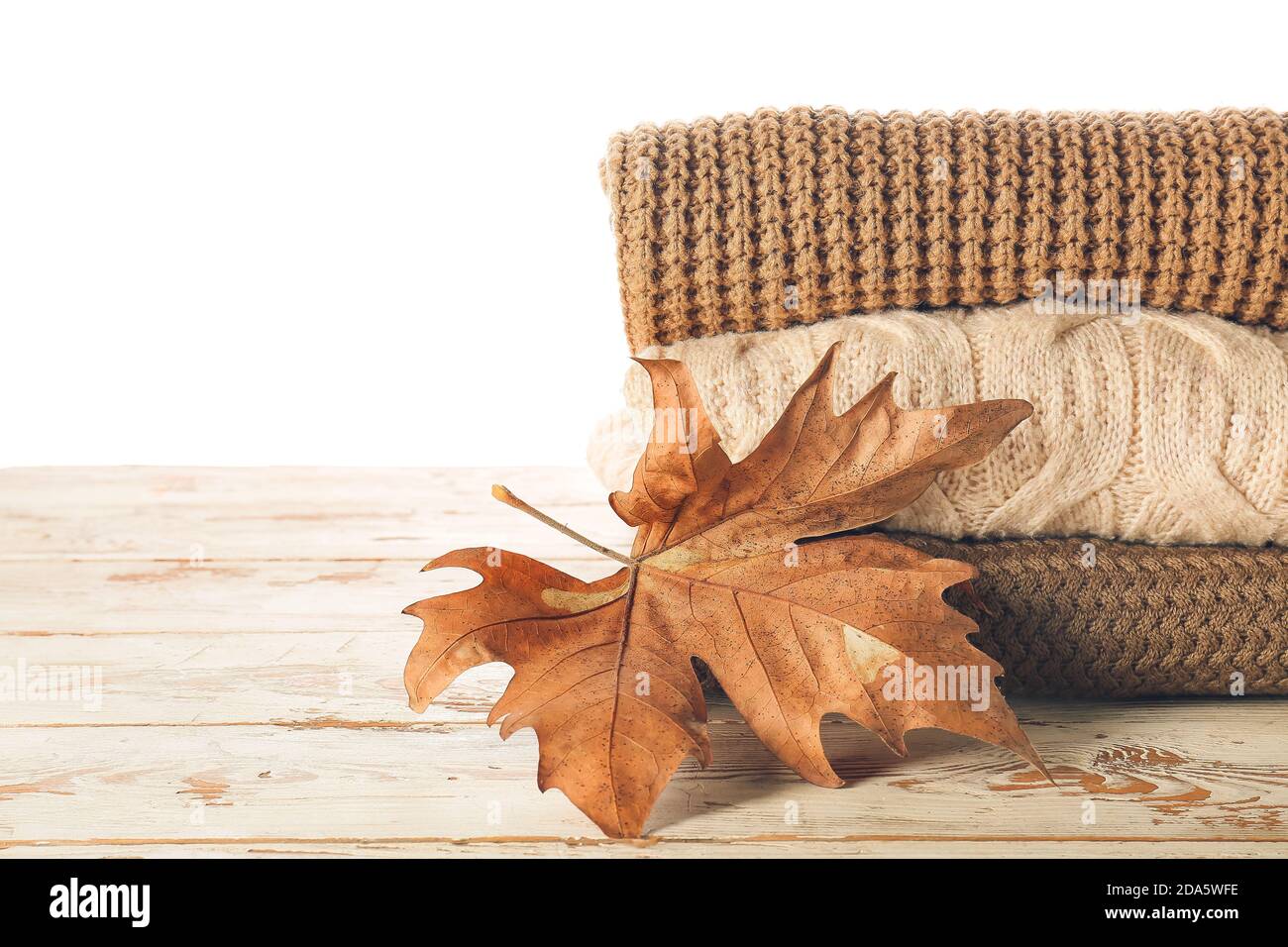 Stylish autumn clothes on table against white background Stock Photo ...