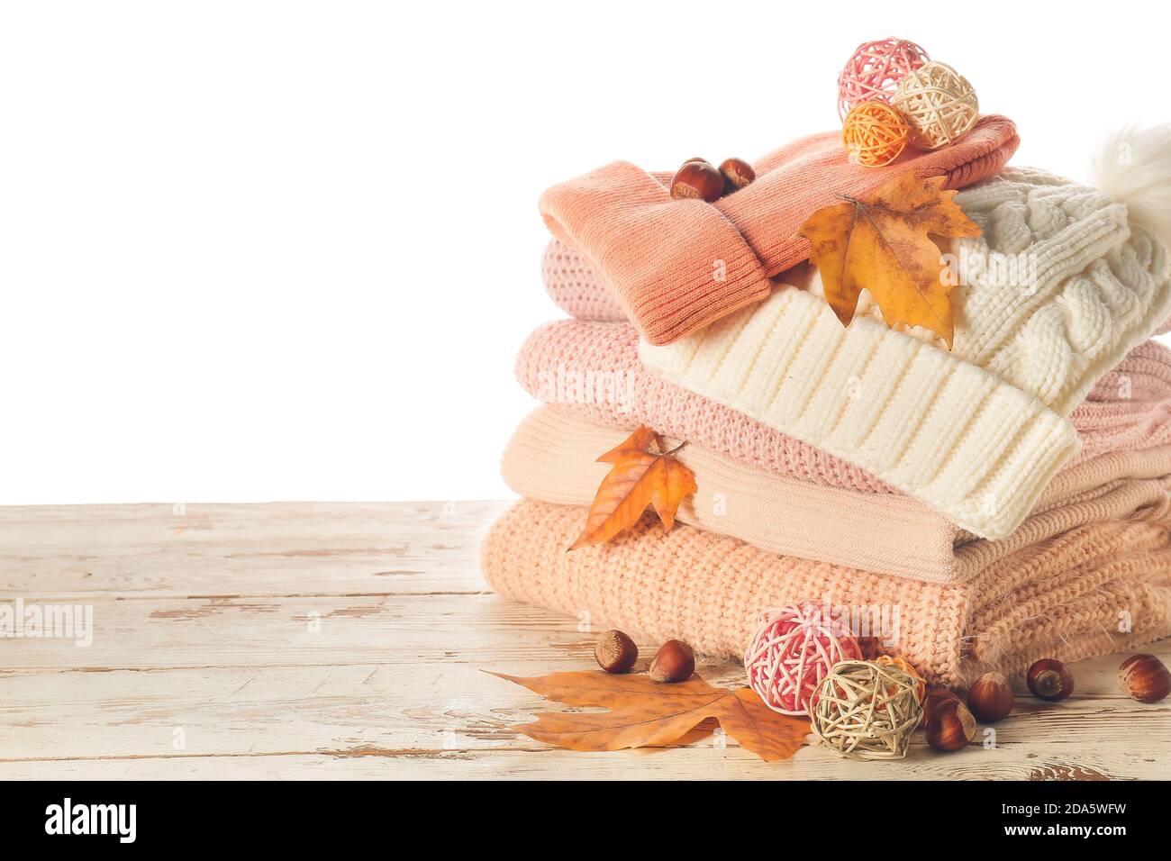 Stylish autumn clothes on table against white background Stock Photo ...