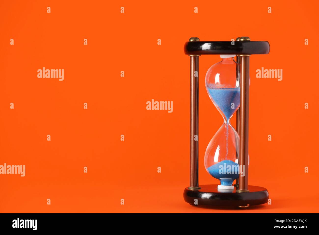 Hourglass on color background. Time management concept Stock Photo - Alamy