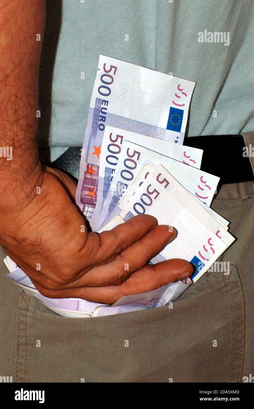 money putting money in his pocket, corruption and tax fraud Stock Photo ...