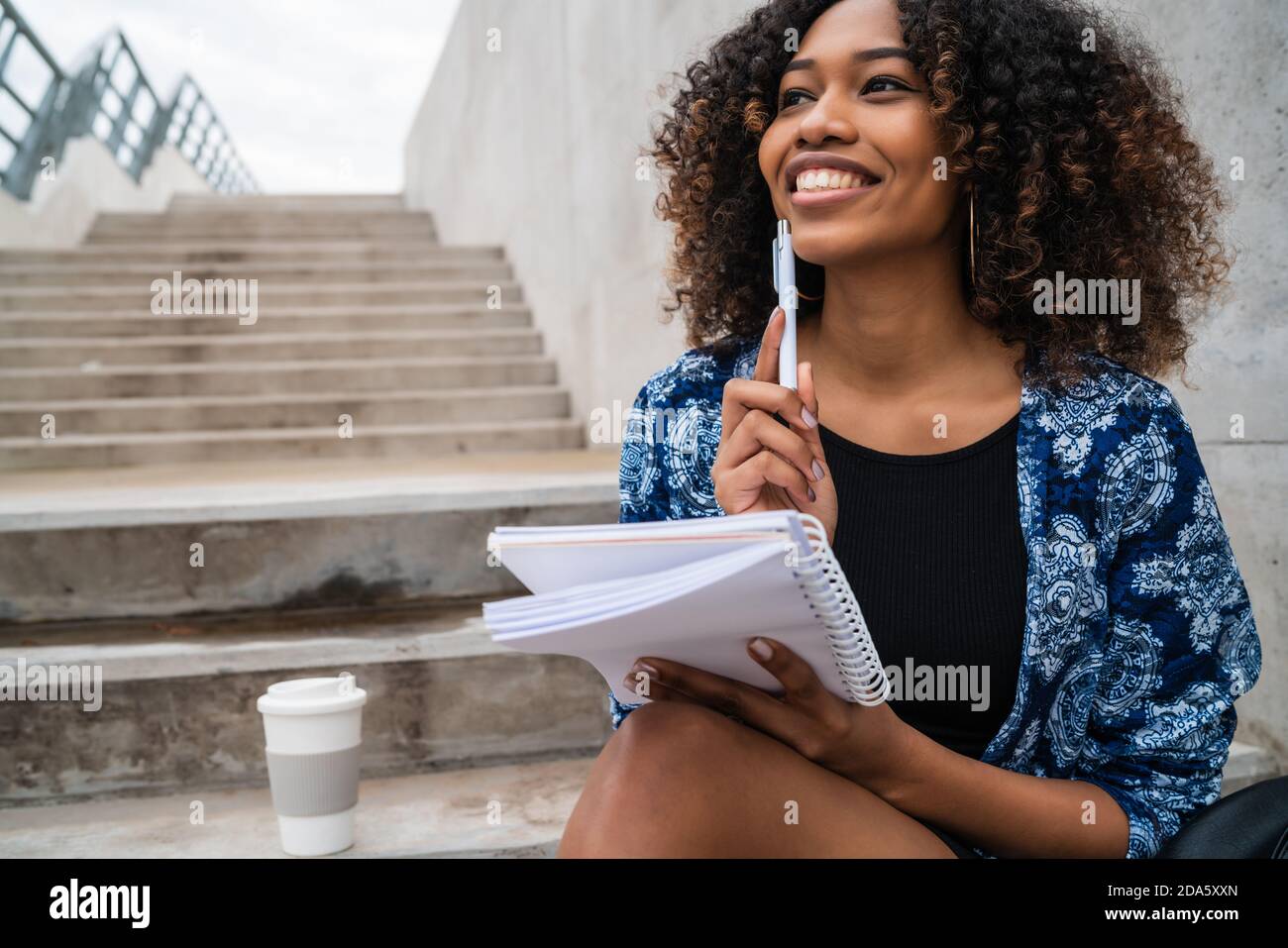 Afro-american women with notebook and pen Stock Photo - Alamy