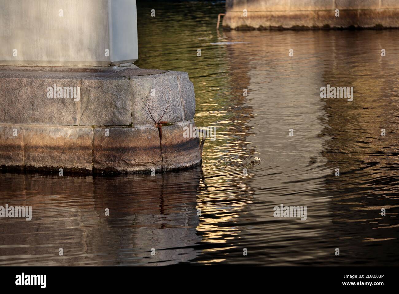 Water flowing under a bridge. Columns made of stone and concrete Stock ...