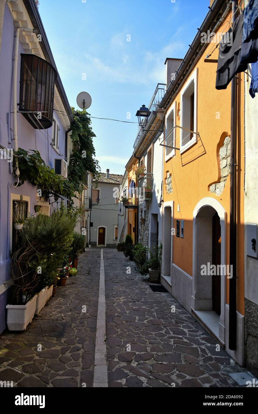 A narrow street among the old houses of Baselice, a rural village in ...