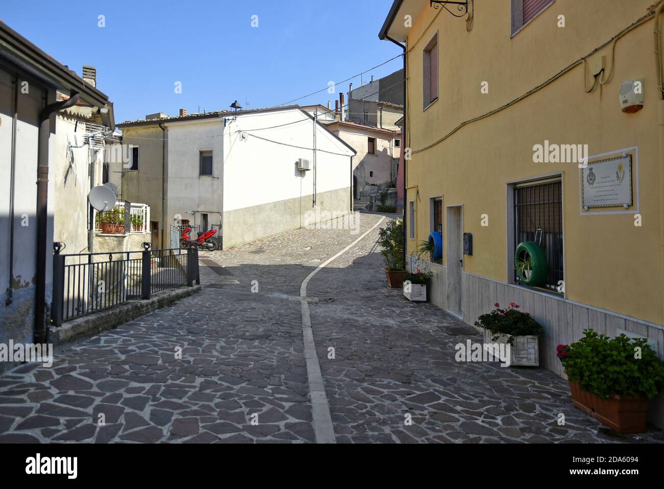 A narrow street among the old houses of Baselice, a rural village in ...