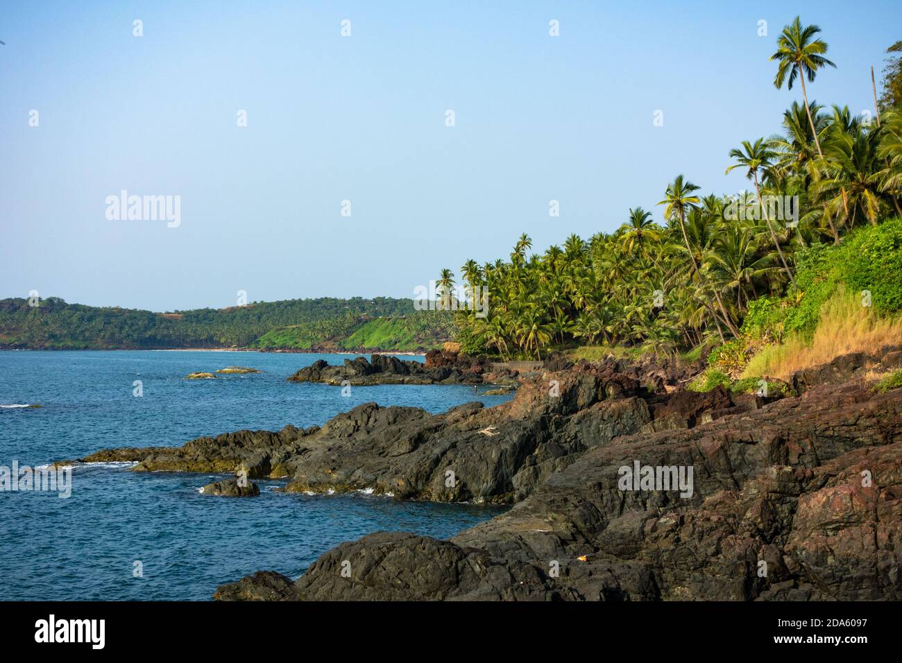 Arabian sea meets rocky shoreline and coconut palm trees at Cabo de ...