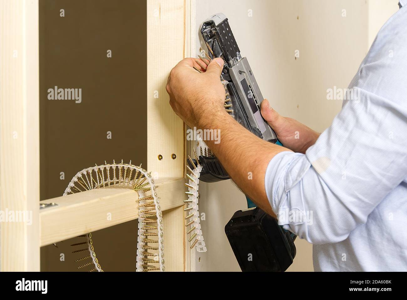 Room repair. Building. Worker fastens drywall with a screwdriver close ...