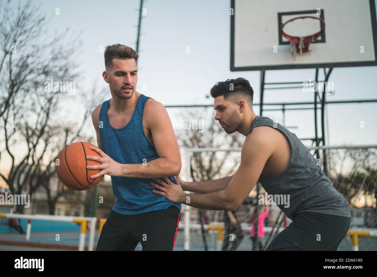 Two young friends playing basketball Stock Photo - Alamy