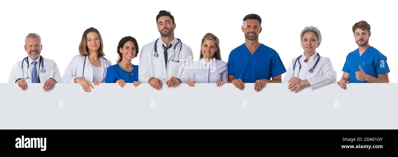 Group of doctors with blank banner isolated over a white background ...