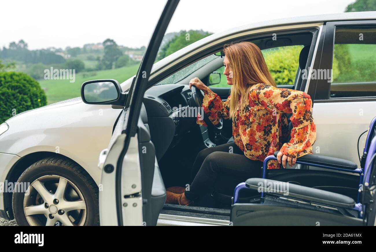 Woman in wheelchair leaving the car Stock Photo - Alamy