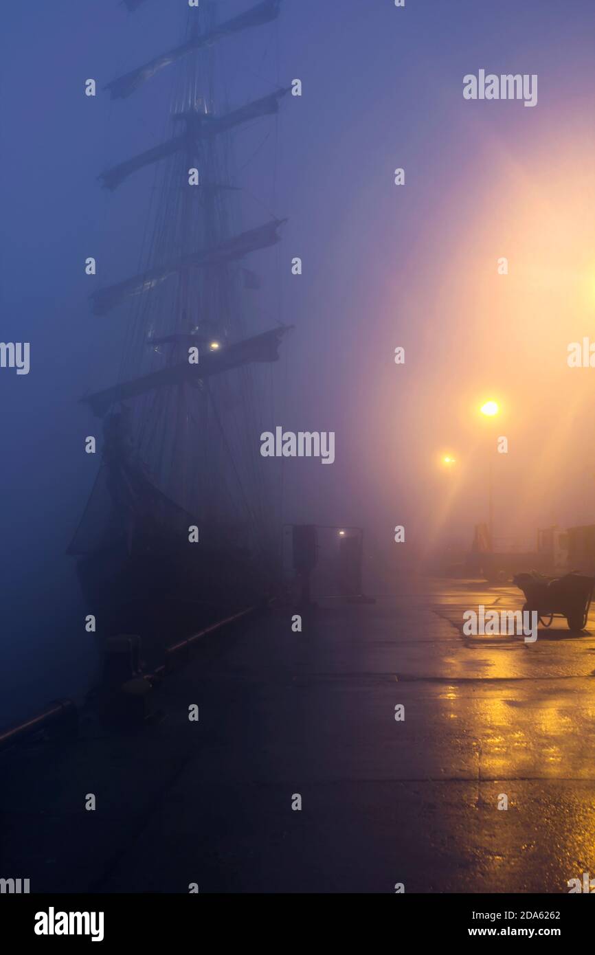 Tall ship in foggy harbour at night in scottish port of Stromness Stock ...