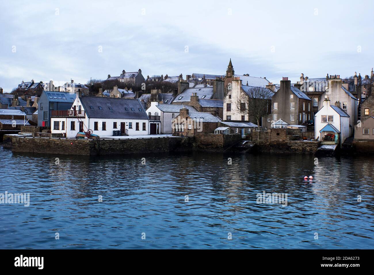 Winter scene in scottish town waterfront with houses covered with snow ...