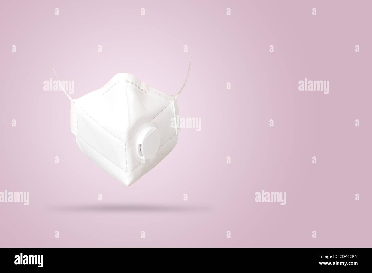 White n95 mask on pink background, n95 respirator with ventilation ...