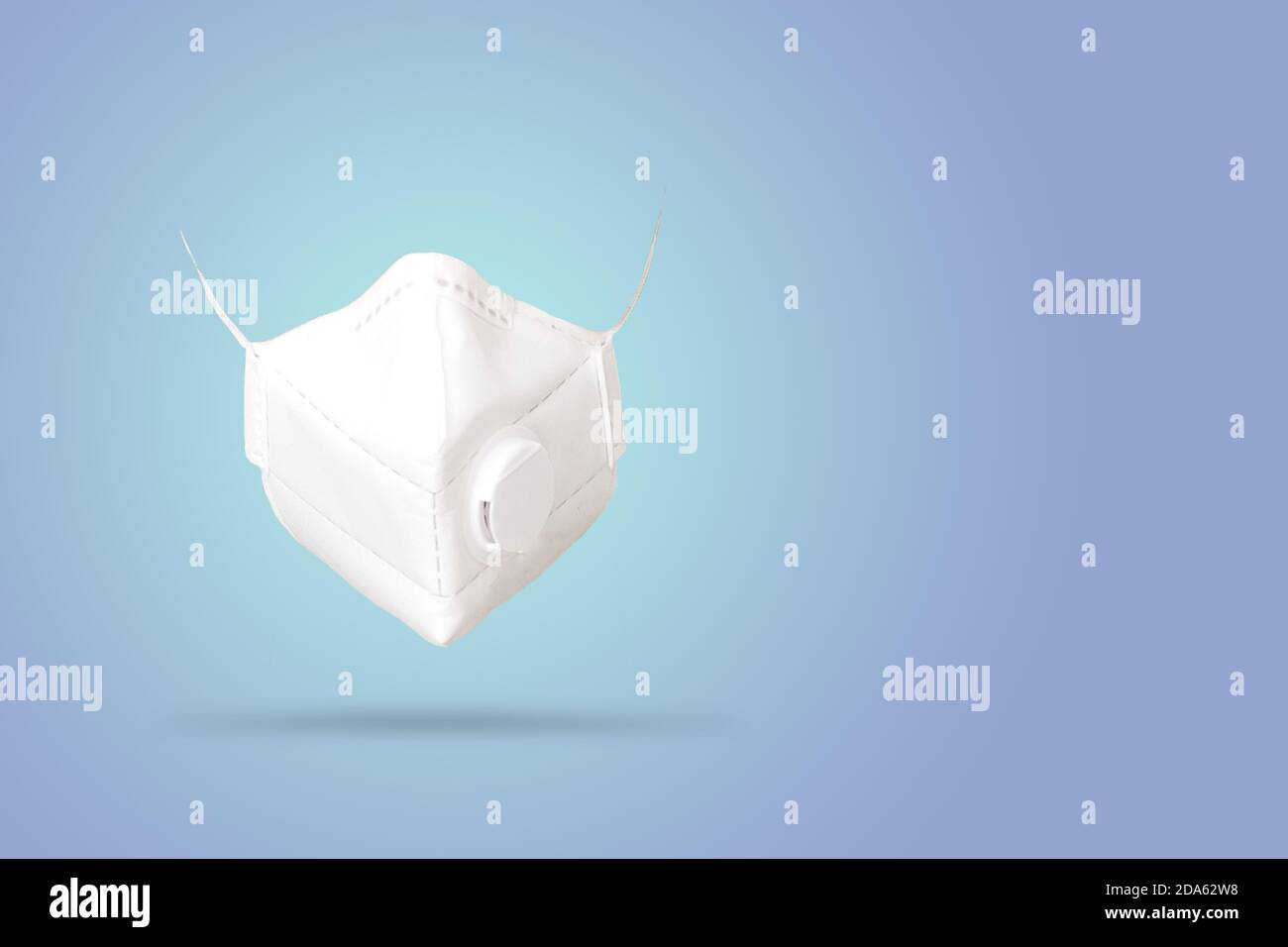 White n95 mask on blue background, n95 respirator with ventilation ...