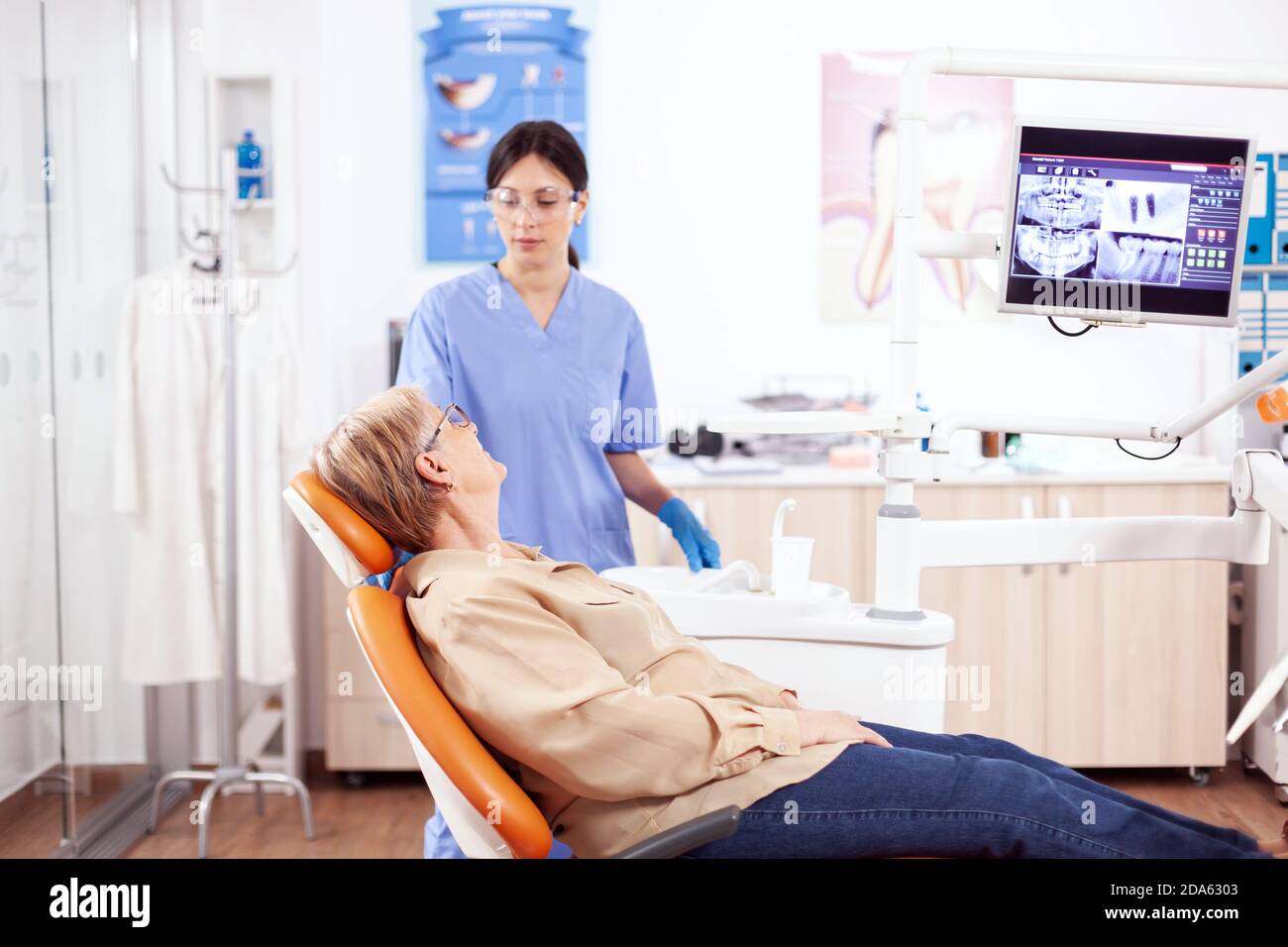 Dentist patient having conversation in hi-res stock photography and ...